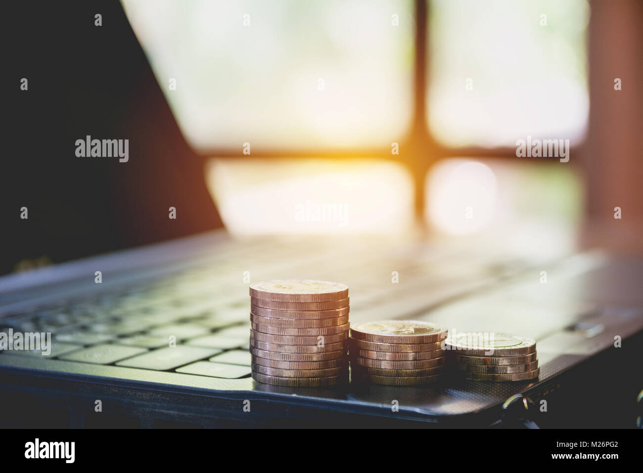 Stack coins on laptop. Financial, accounting and saving concept Stock ...