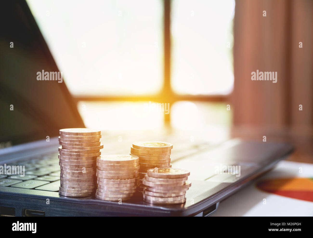 Stack coins on laptop. Financial, accounting and saving concept Stock ...
