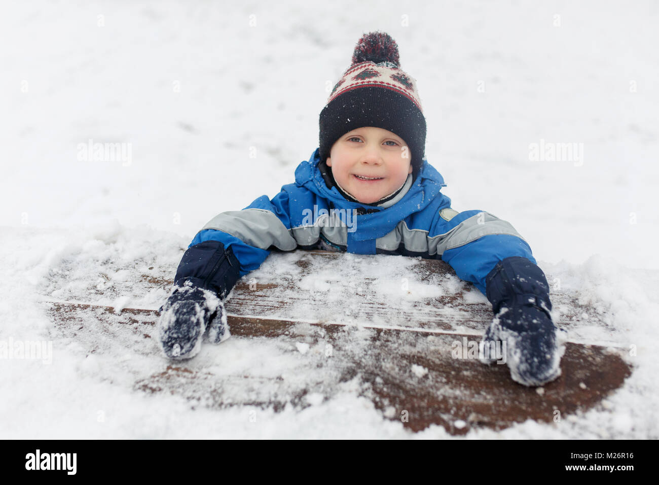 Photo of little boy in snow on park Stock Photo - Alamy