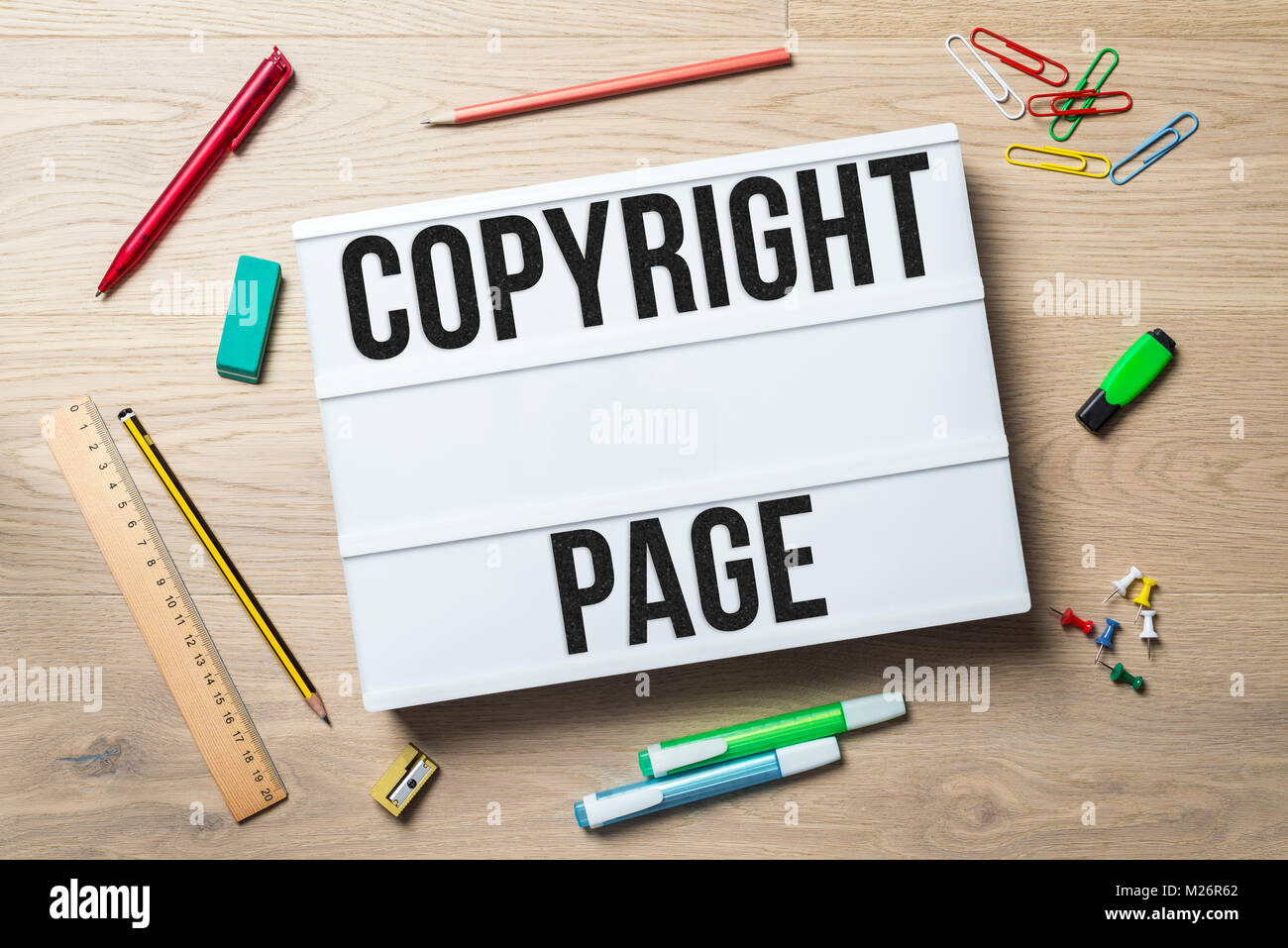 Copyright page writing on lightbox with pen, pencil, highlighter and ...