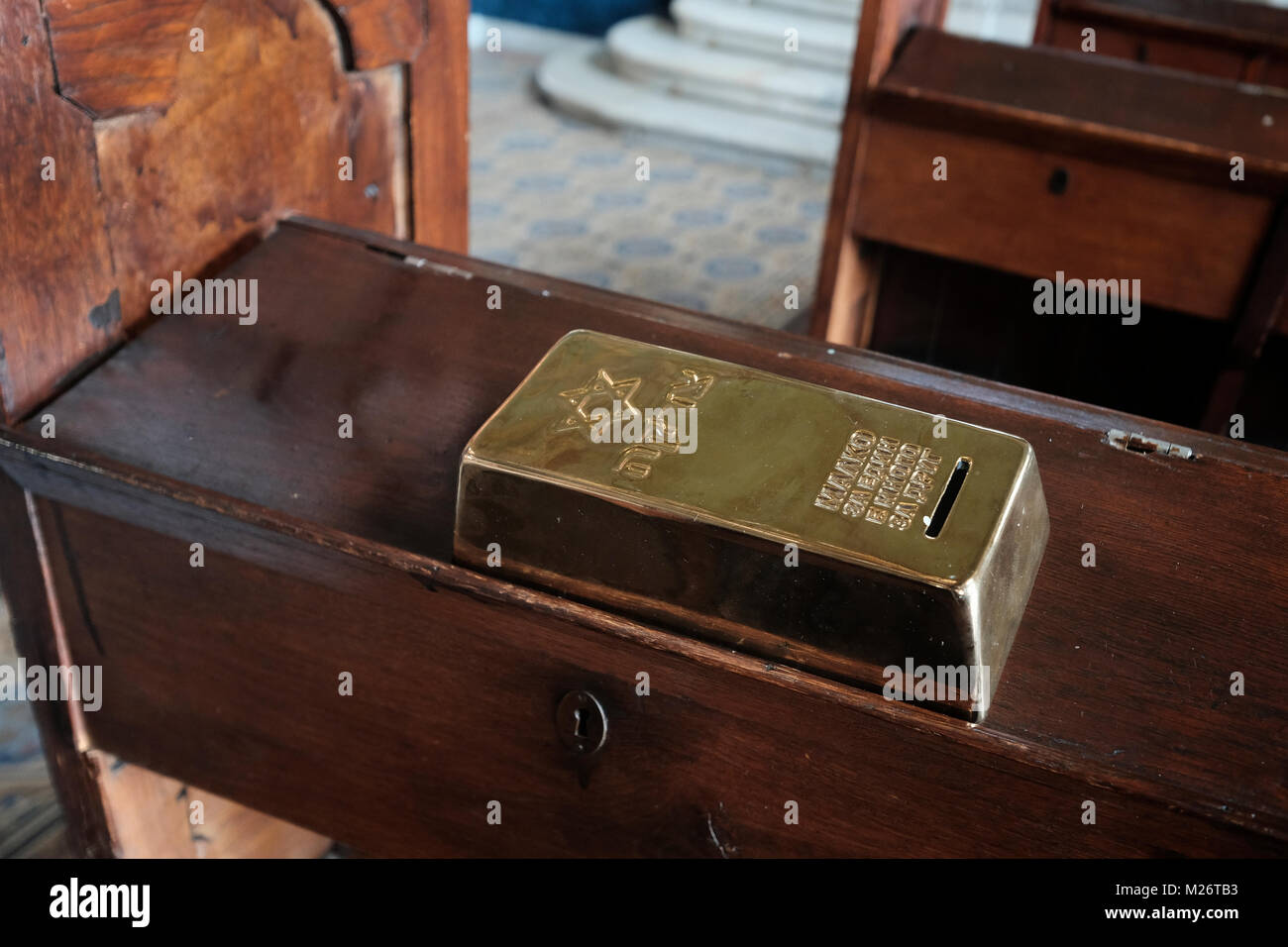 A charity box for donations in the shape of a gold bullion inside the ...