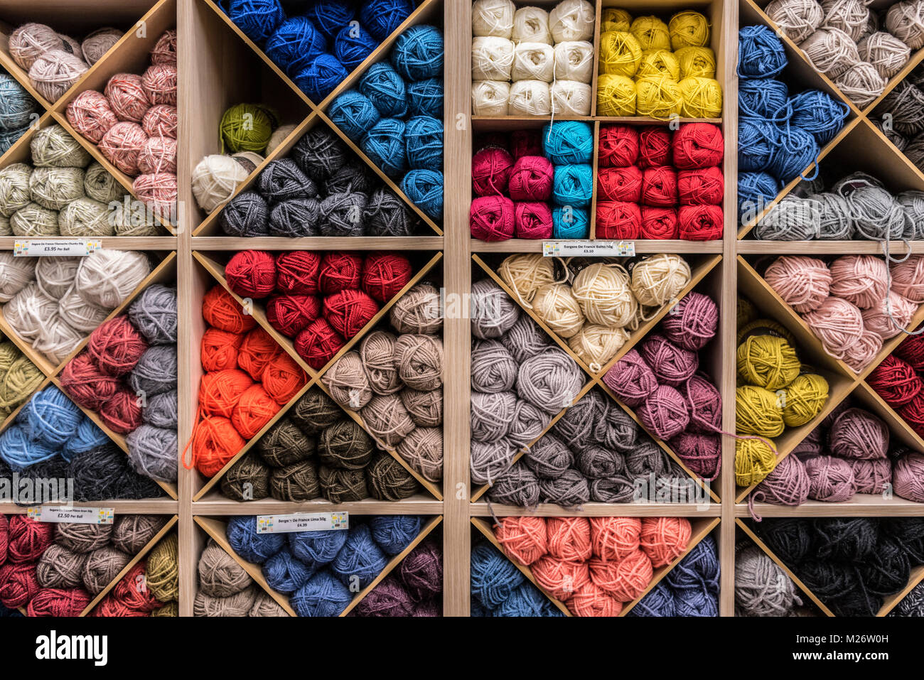 Skeins of wool in a rack Stock Photo - Alamy