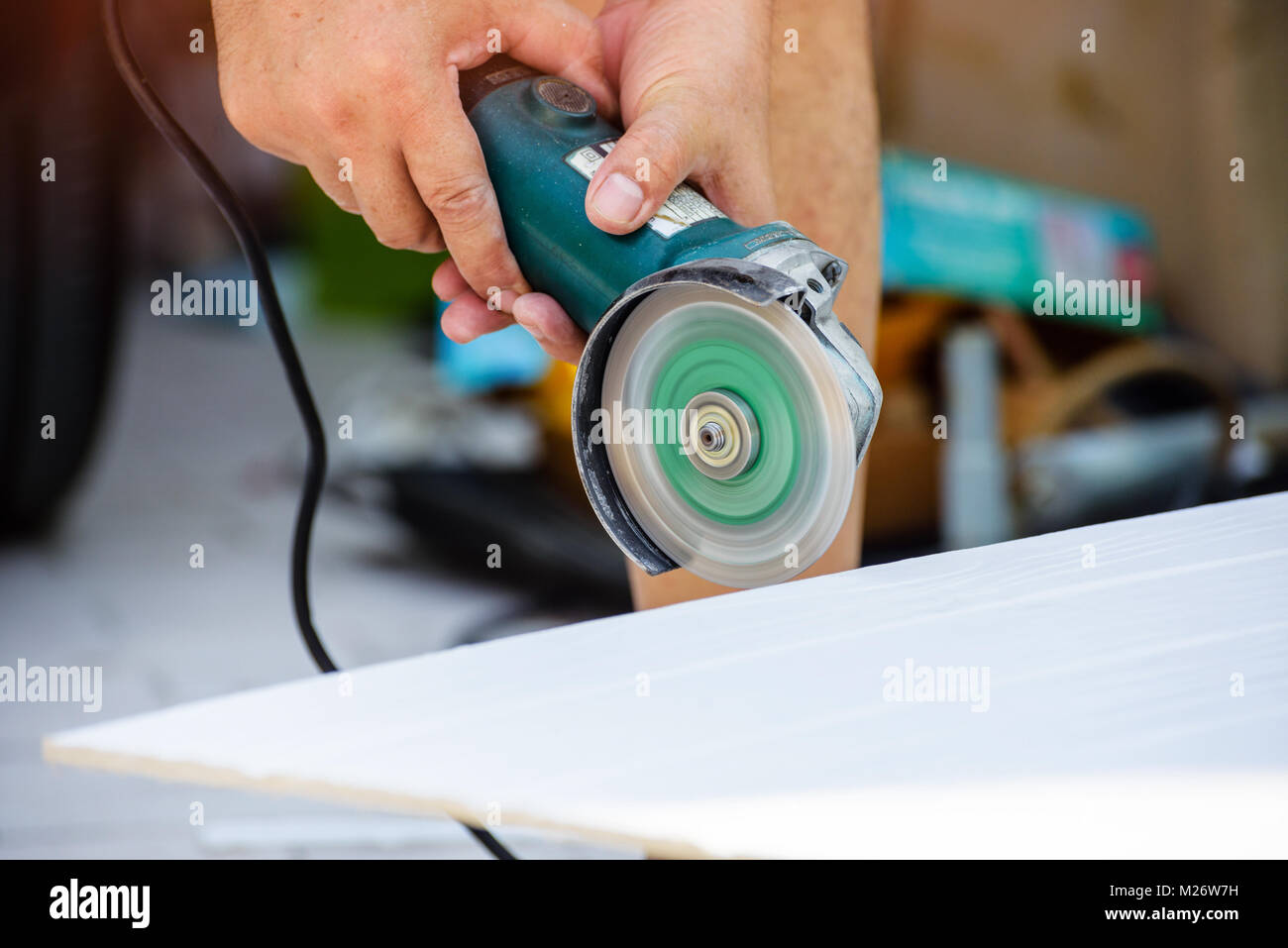 worker cutting ceiling with angle grinder in construction site Stock ...