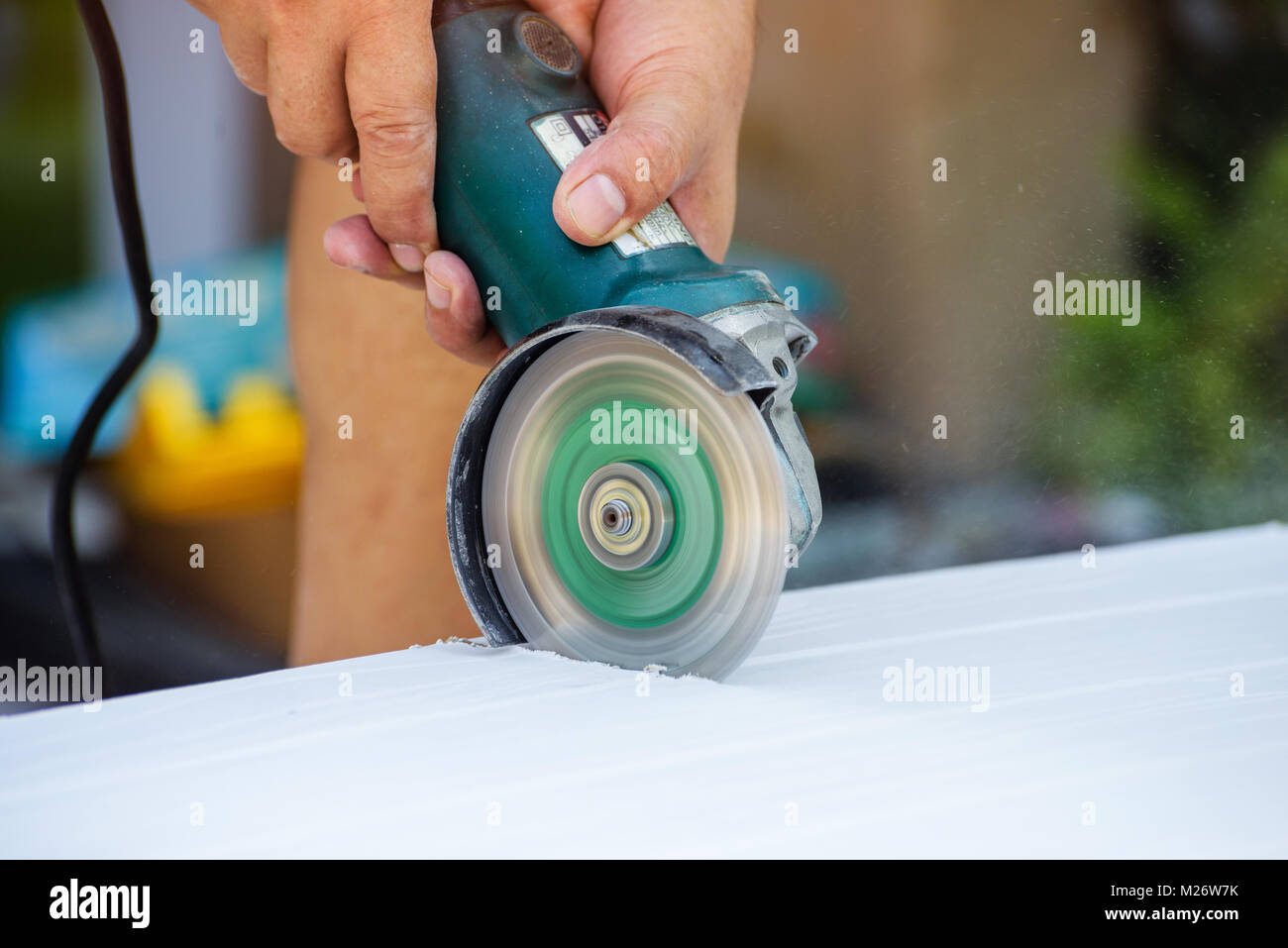 worker cutting ceiling with angle grinder in construction site Stock ...
