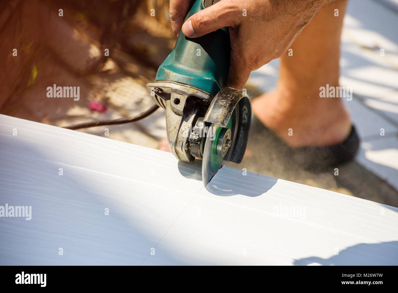 worker cutting ceiling with angle grinder in construction site Stock ...