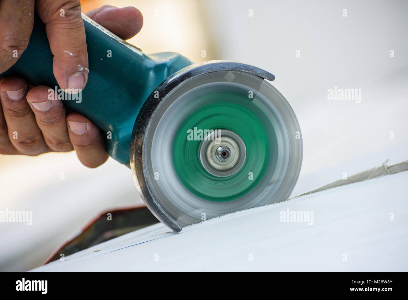 worker cutting ceiling with angle grinder in construction site Stock ...