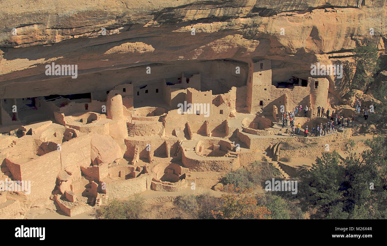 A group of tourists on a tour of the ancient Cliff Dwellings of Mesa ...