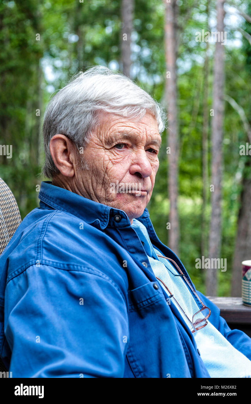 A silver haired octogenarian sitting ouside Stock Photo - Alamy