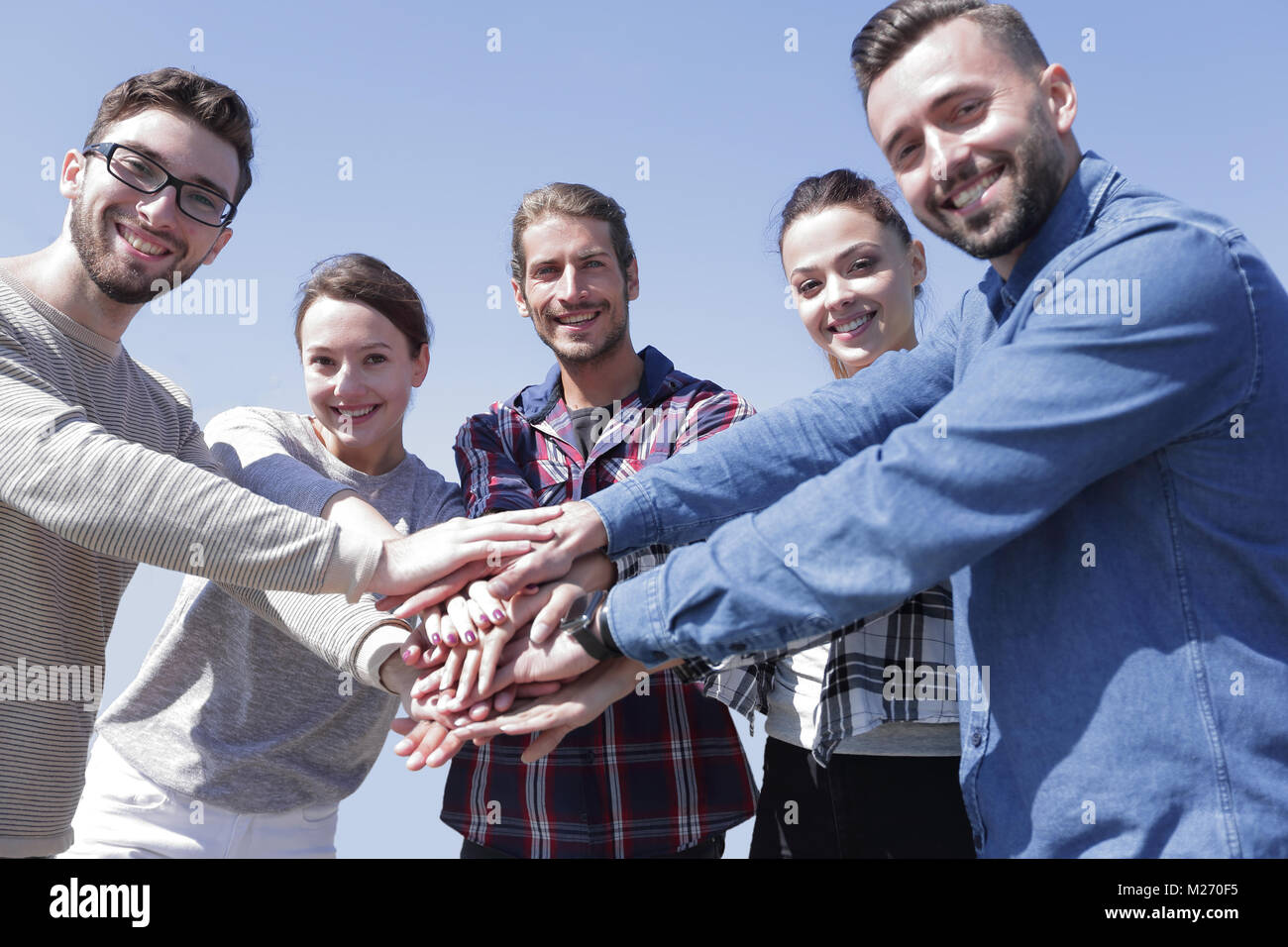 Standing friends joined hands hi-res stock photography and images - Alamy