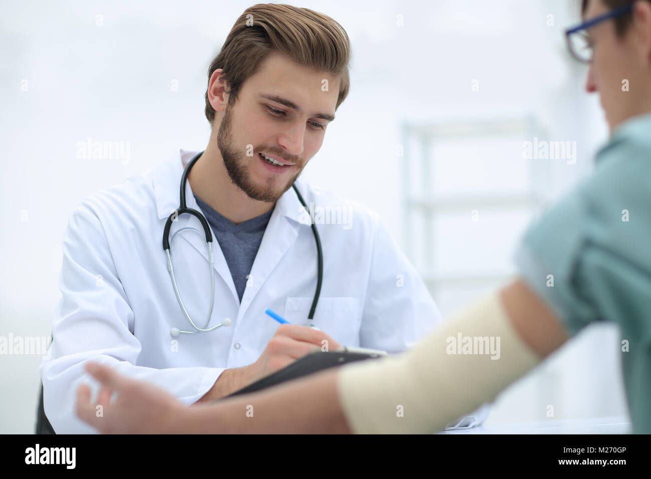 doctor writing a prescription to her patient Stock Photo - Alamy