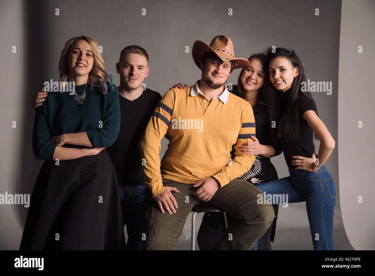 Five young friends standing together. The studio shot Stock Photo - Alamy