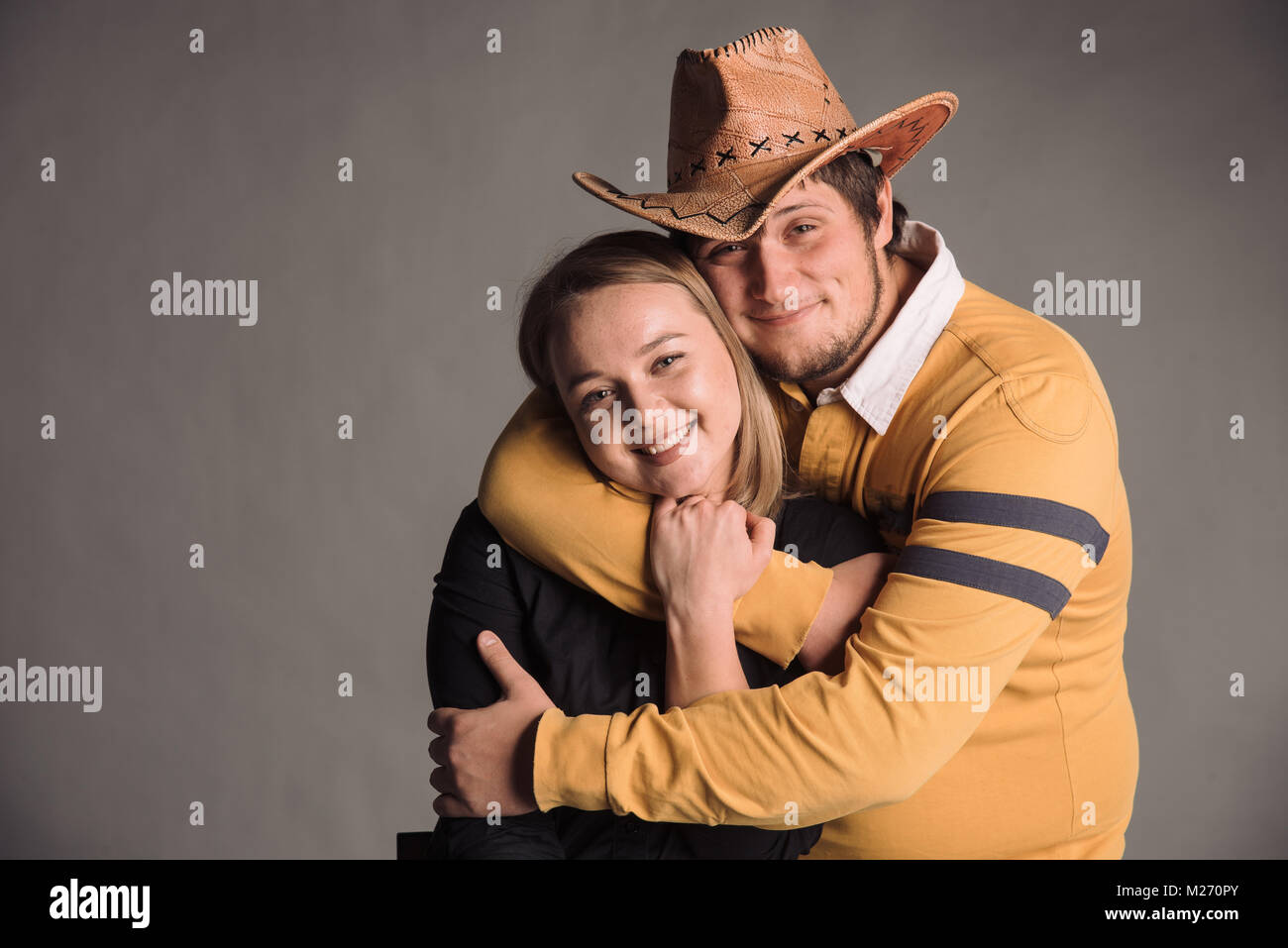 Two young friends standing together. The studio shot Stock Photo - Alamy