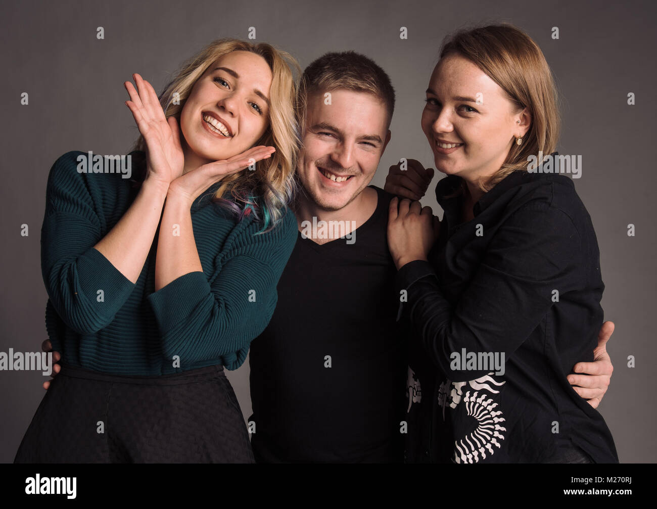 Three young friends standing together, The studio shot Stock Photo - Alamy