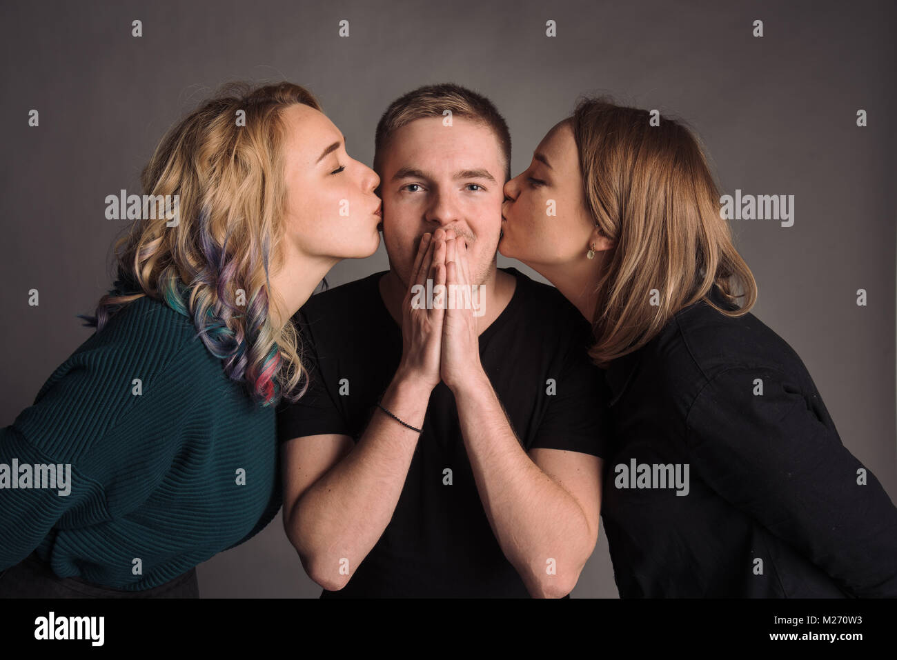 Three young friends standing together, The studio shot Stock Photo - Alamy