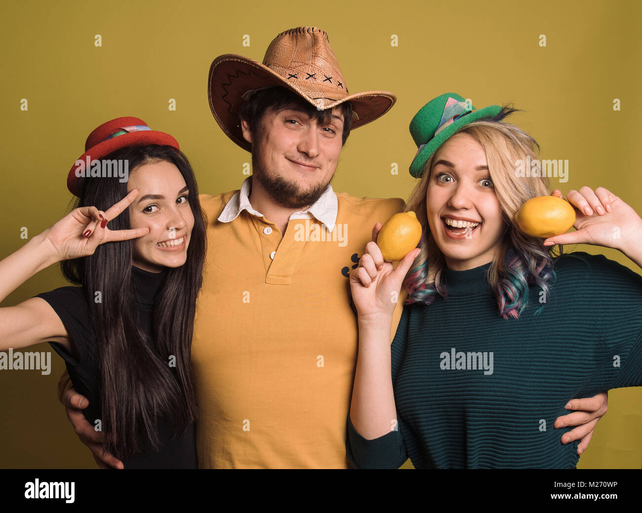 Three young friends standing together, The studio shot Stock Photo - Alamy
