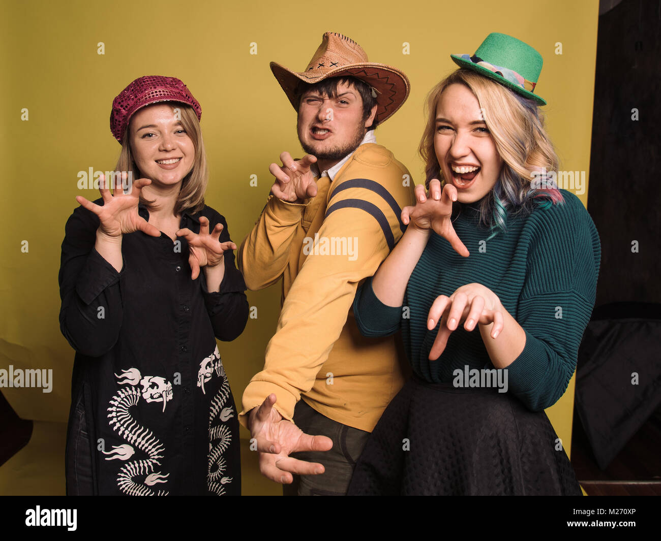 Three young friends standing together. The studio shot Stock Photo - Alamy
