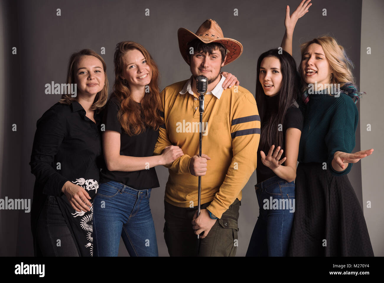 Five young friends standing together. The studio shot Stock Photo - Alamy