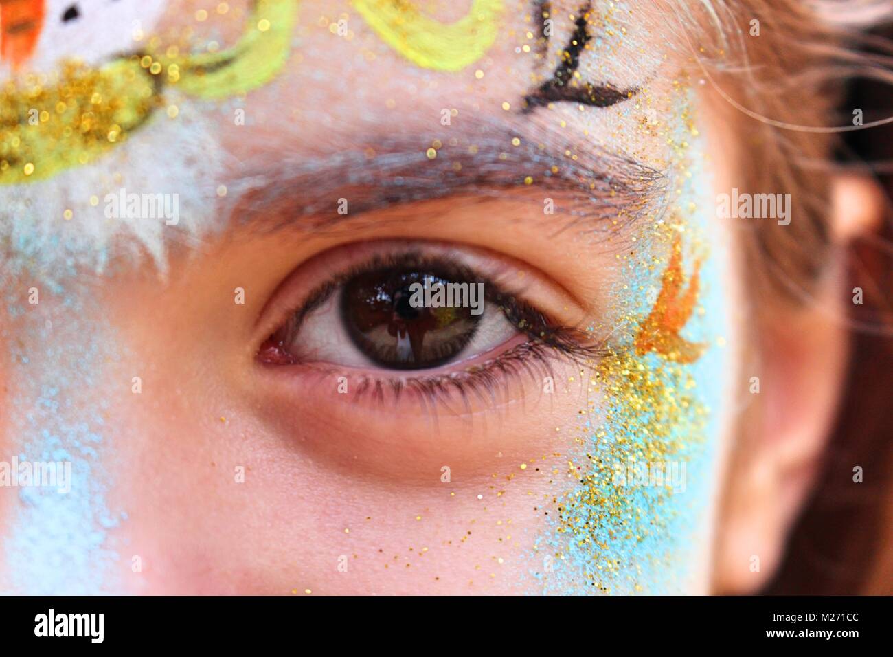 A beautiful girl eye and a painted face Stock Photo - Alamy