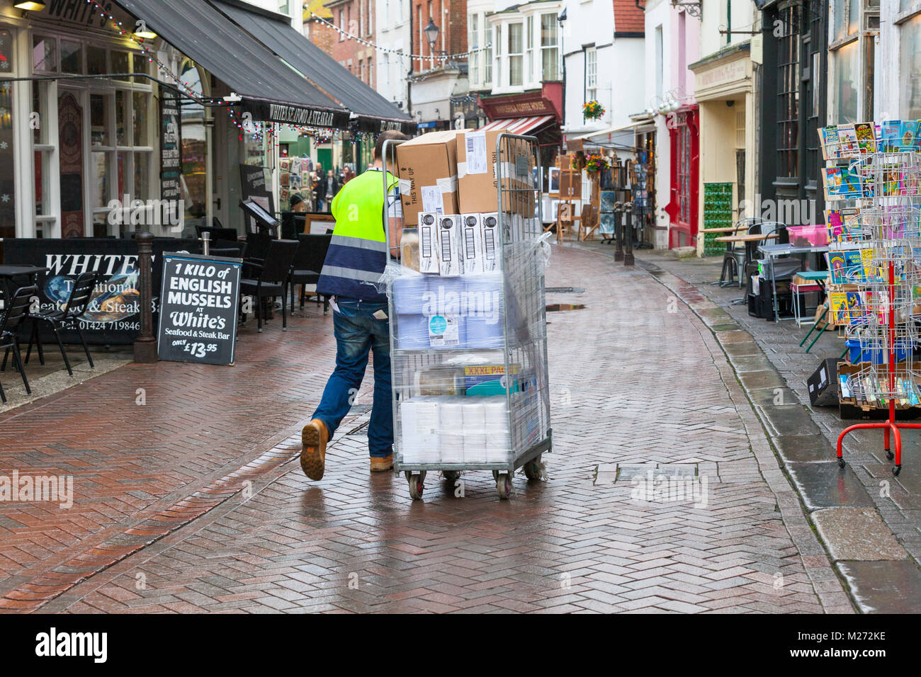 Man pulling trolley hi-res stock photography and images - Alamy