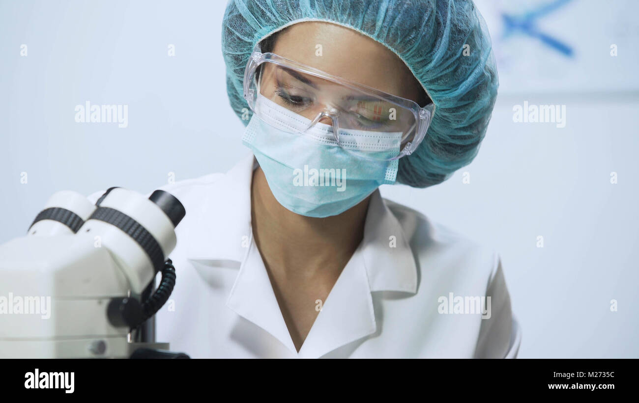 Lab researcher working on microscope at university laboratory, close-up ...