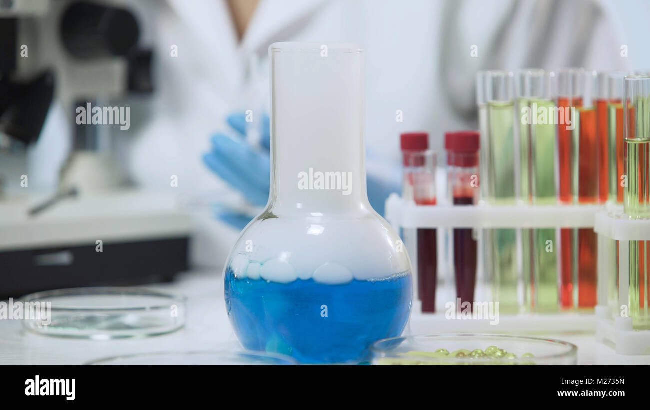 View of laboratory flask with evaporating liquid, chemical experiment ...