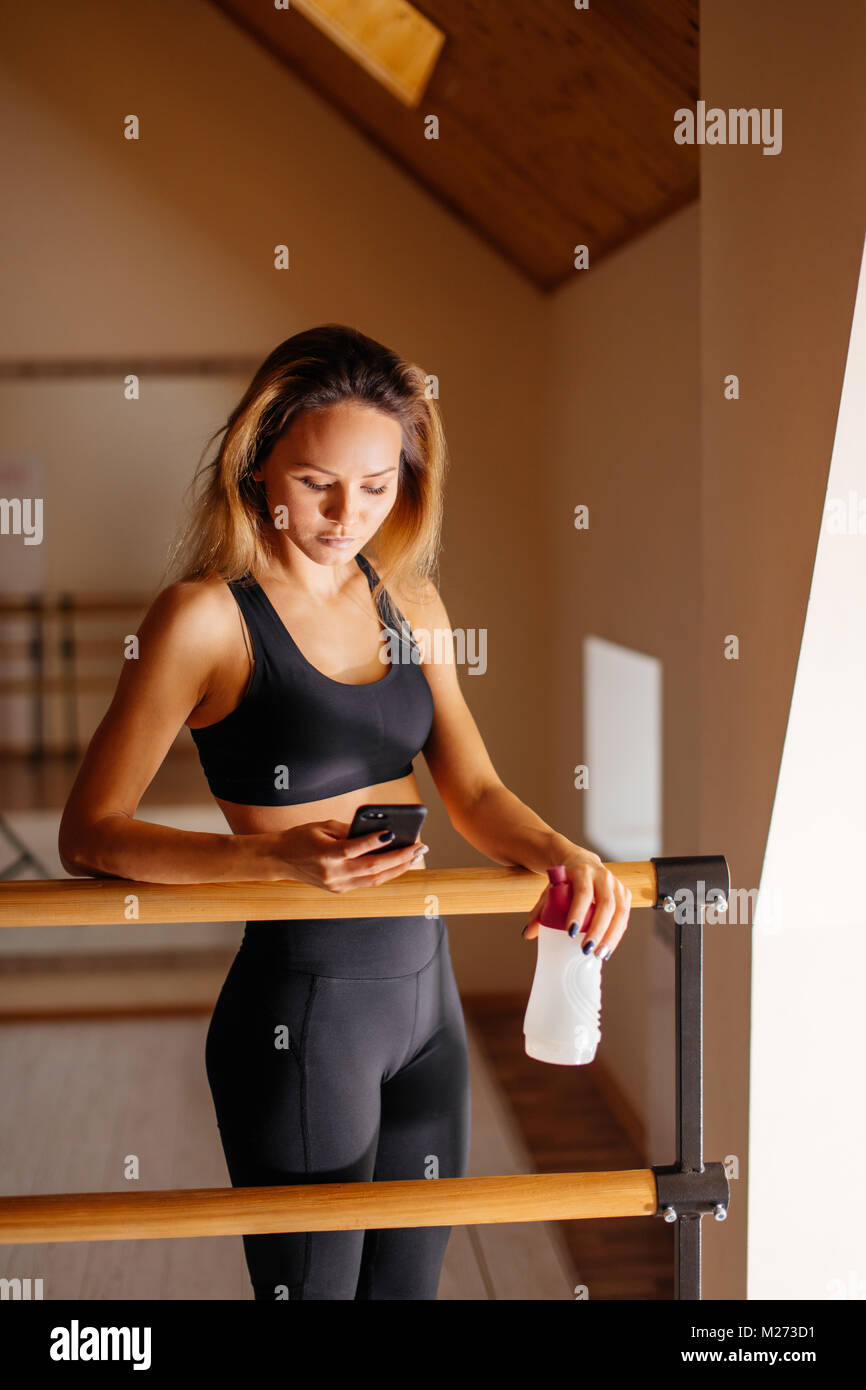 female dancer using phone by mirror Stock Photo - Alamy
