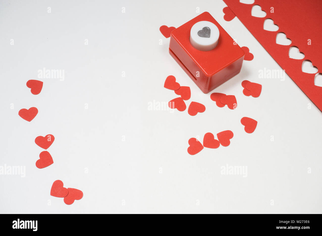 Decoration for Valentine's Day: hole puncher made paper shapes of red ...