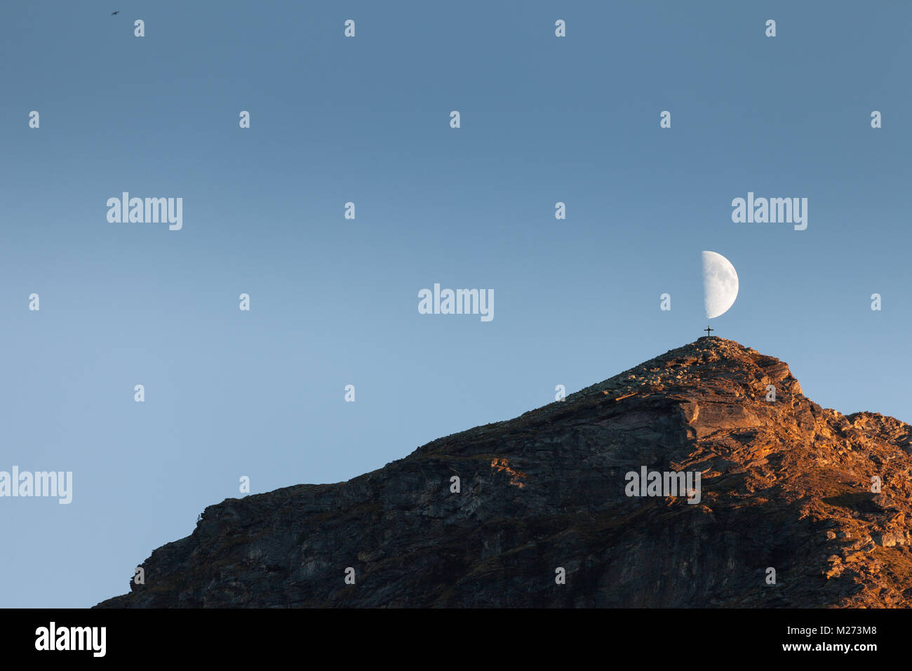 the Moon over a peak in Valle di RIva the northern Italian side of ...