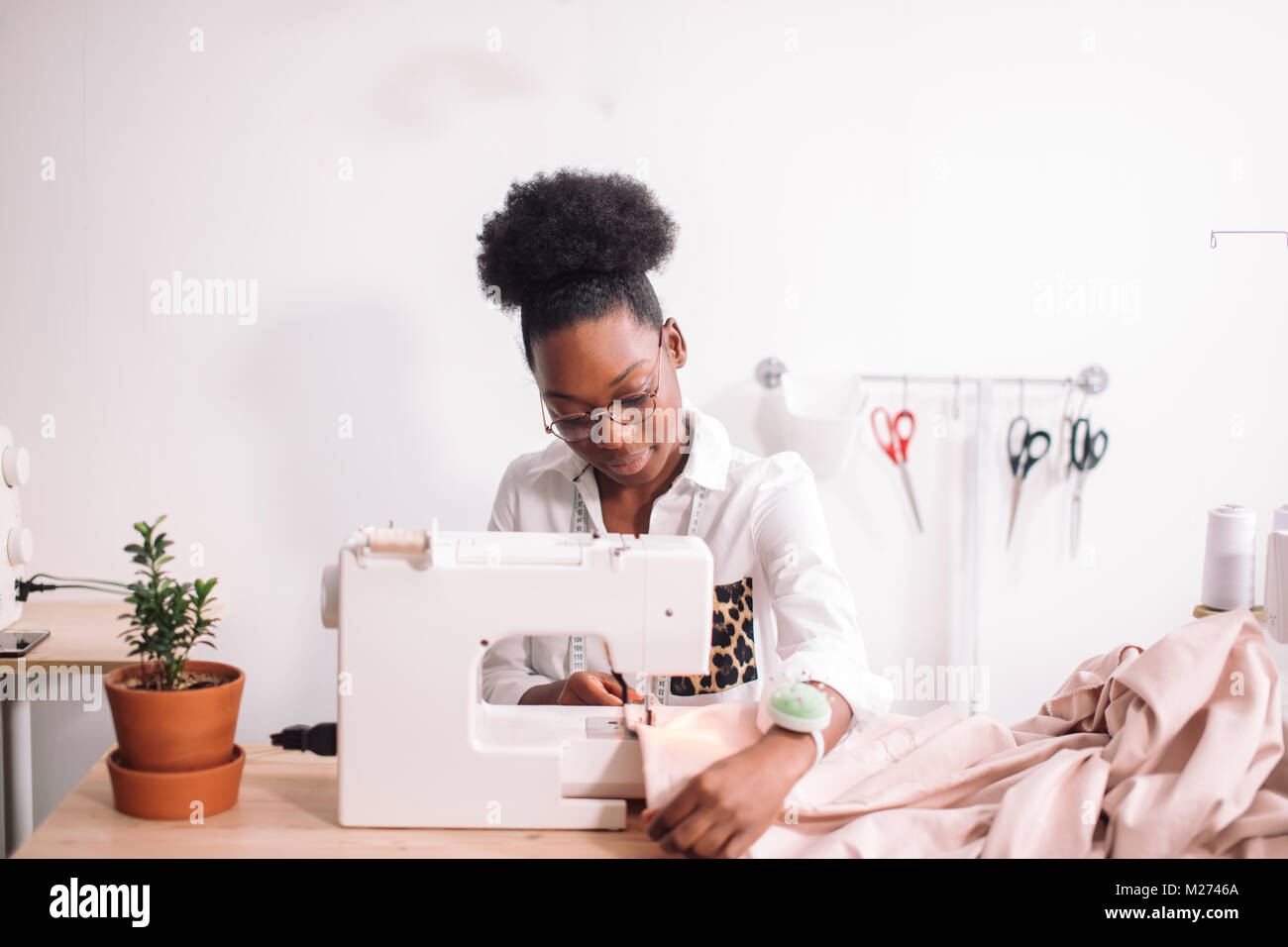 african seamstress sews clothes Stock Photo - Alamy