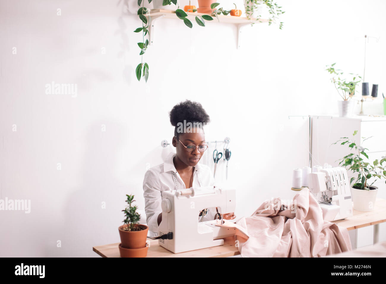 african seamstress sews clothes Stock Photo - Alamy