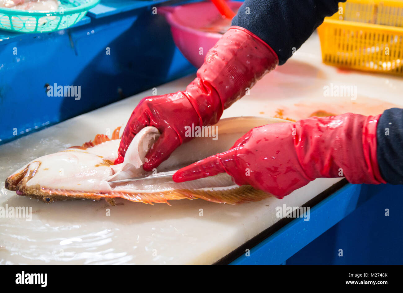 preparing sashimi of flatfish at the seafood market Stock Photo - Alamy