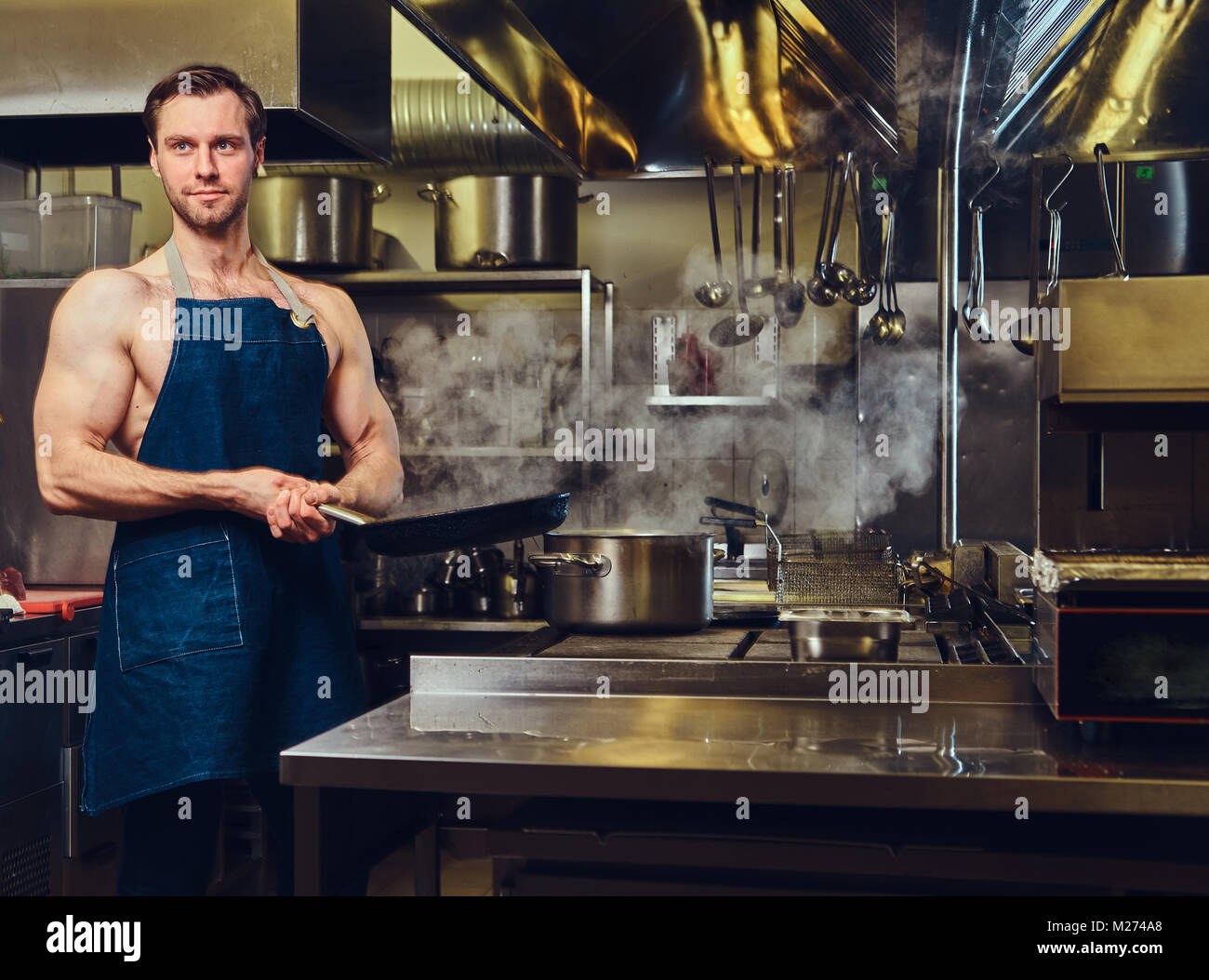 The chef holds dry pan Stock Photo - Alamy