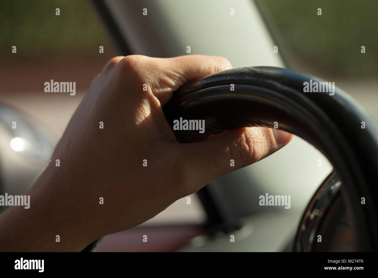 Mans hand steering wheel hi-res stock photography and images - Alamy