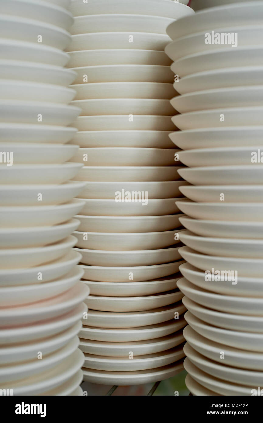 Set of white dishes isolated on white. Stack of plates Stock Photo - Alamy