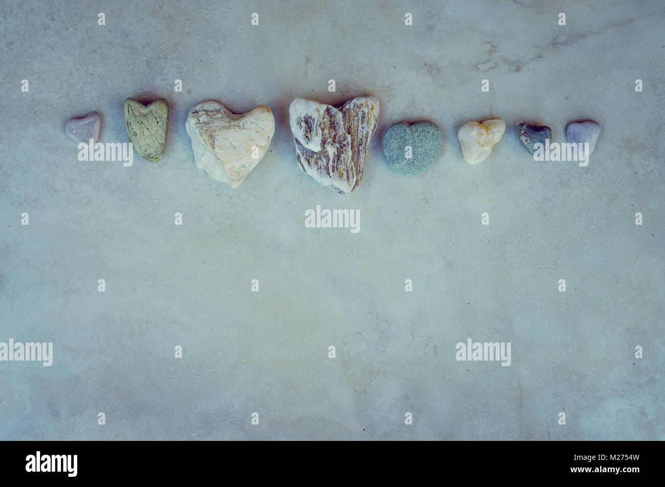 group of heart shaped pebbles decoration Stock Photo - Alamy