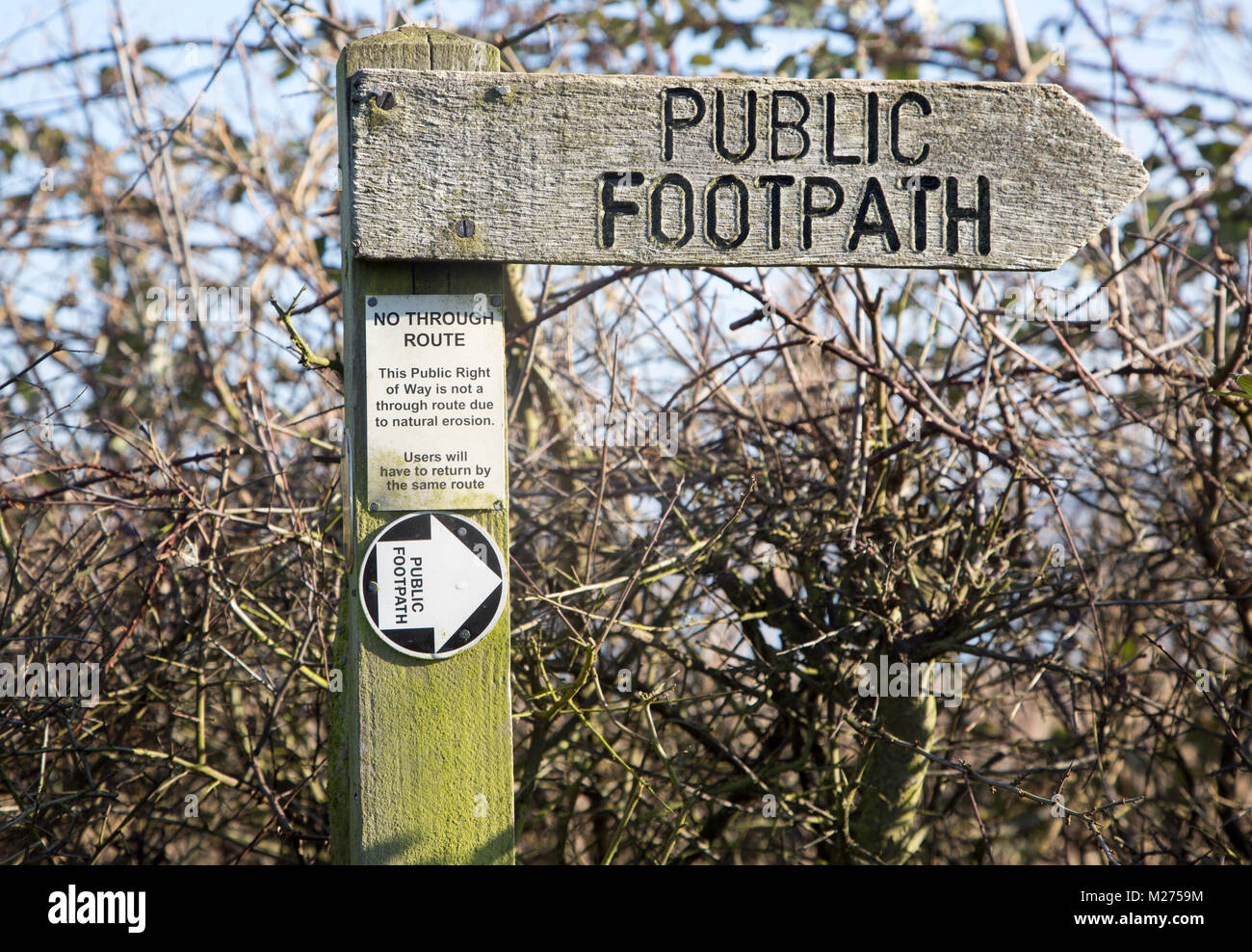 Close up wooden public footpath sign, no through route due to coastal ...