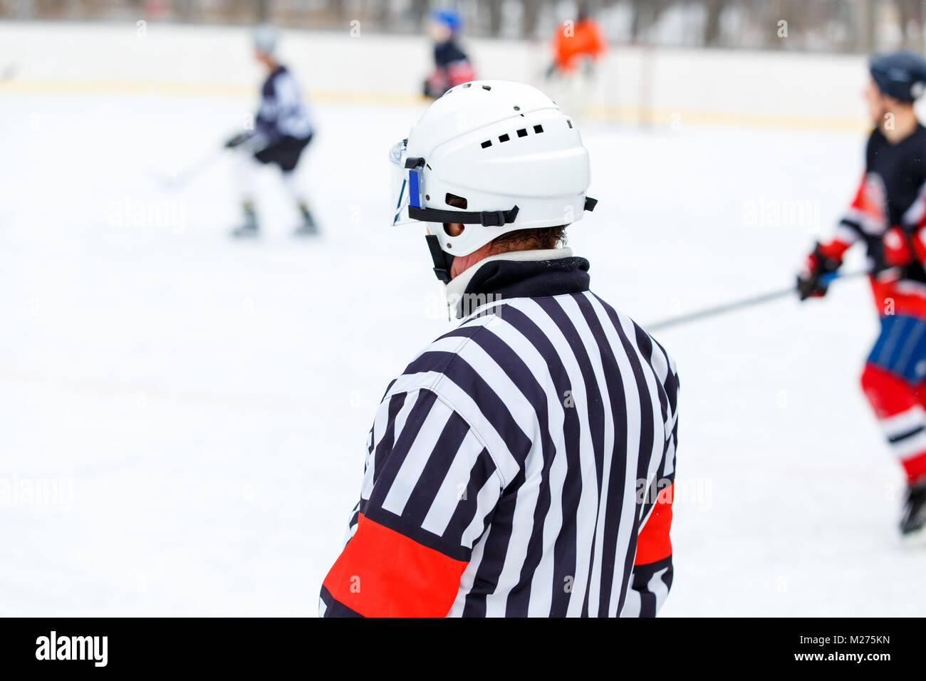 Referee on rink on ice hockey game Stock Photo - Alamy