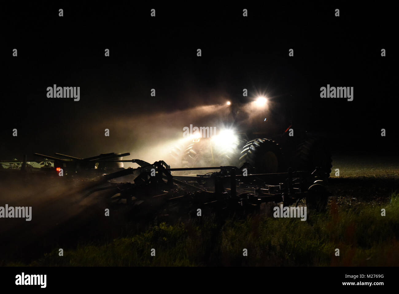 Farmer working the field at night Stock Photo - Alamy