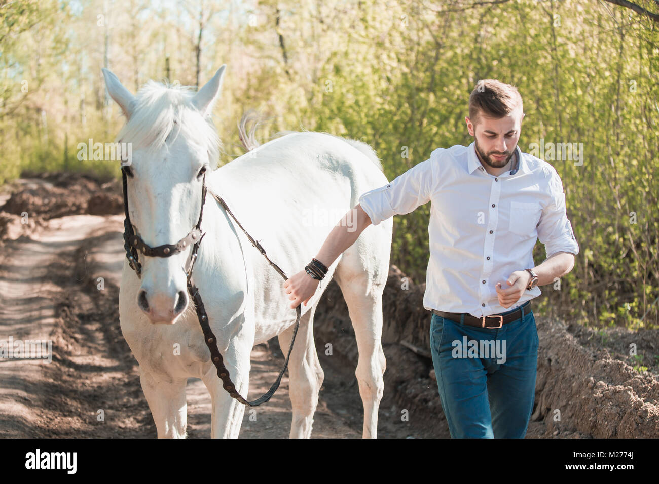 Young man with horse. Autumn outdoors scene Stock Photo - Alamy