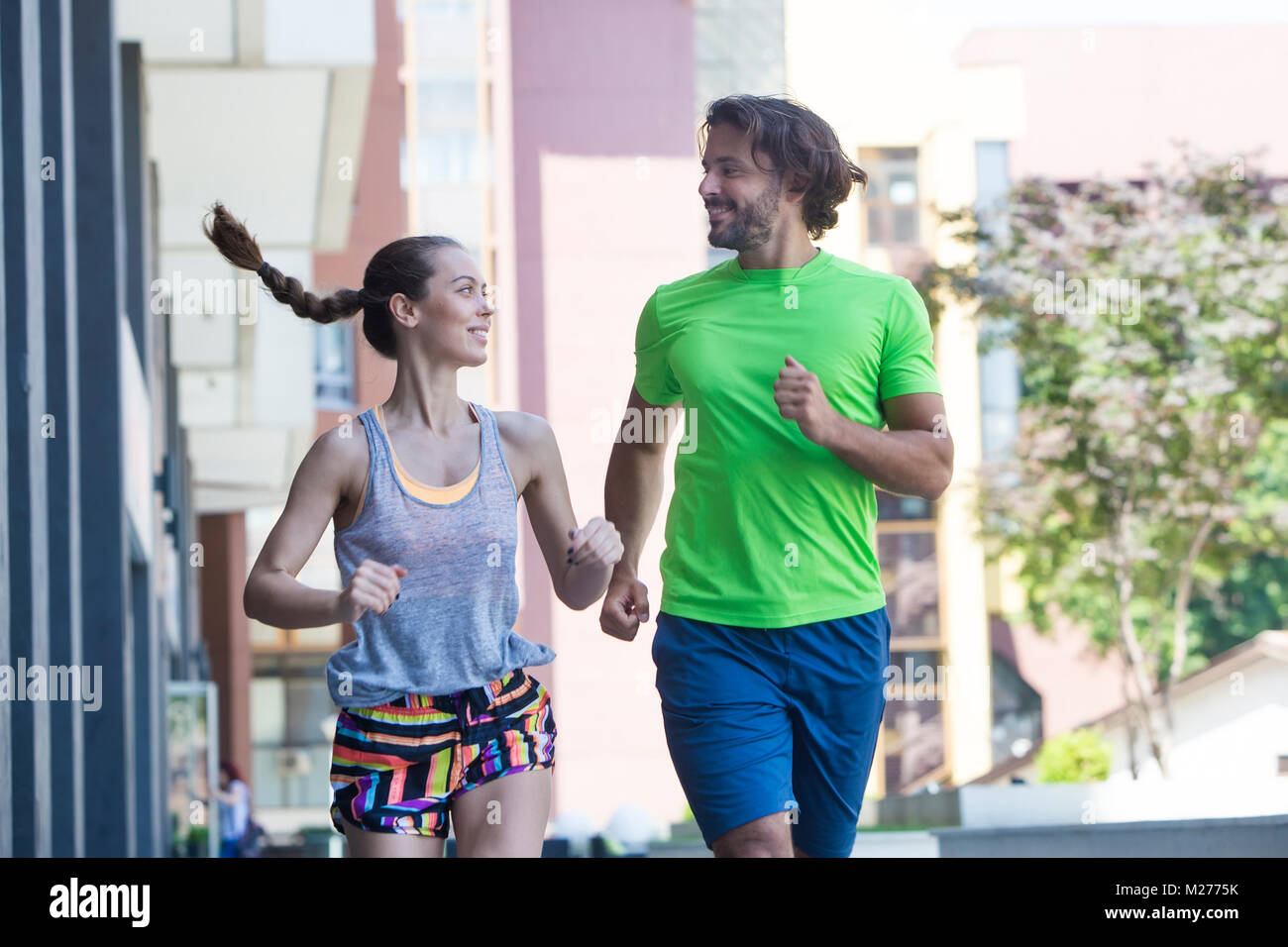 Couple running in urban enviroment at hot summer day Stock Photo - Alamy