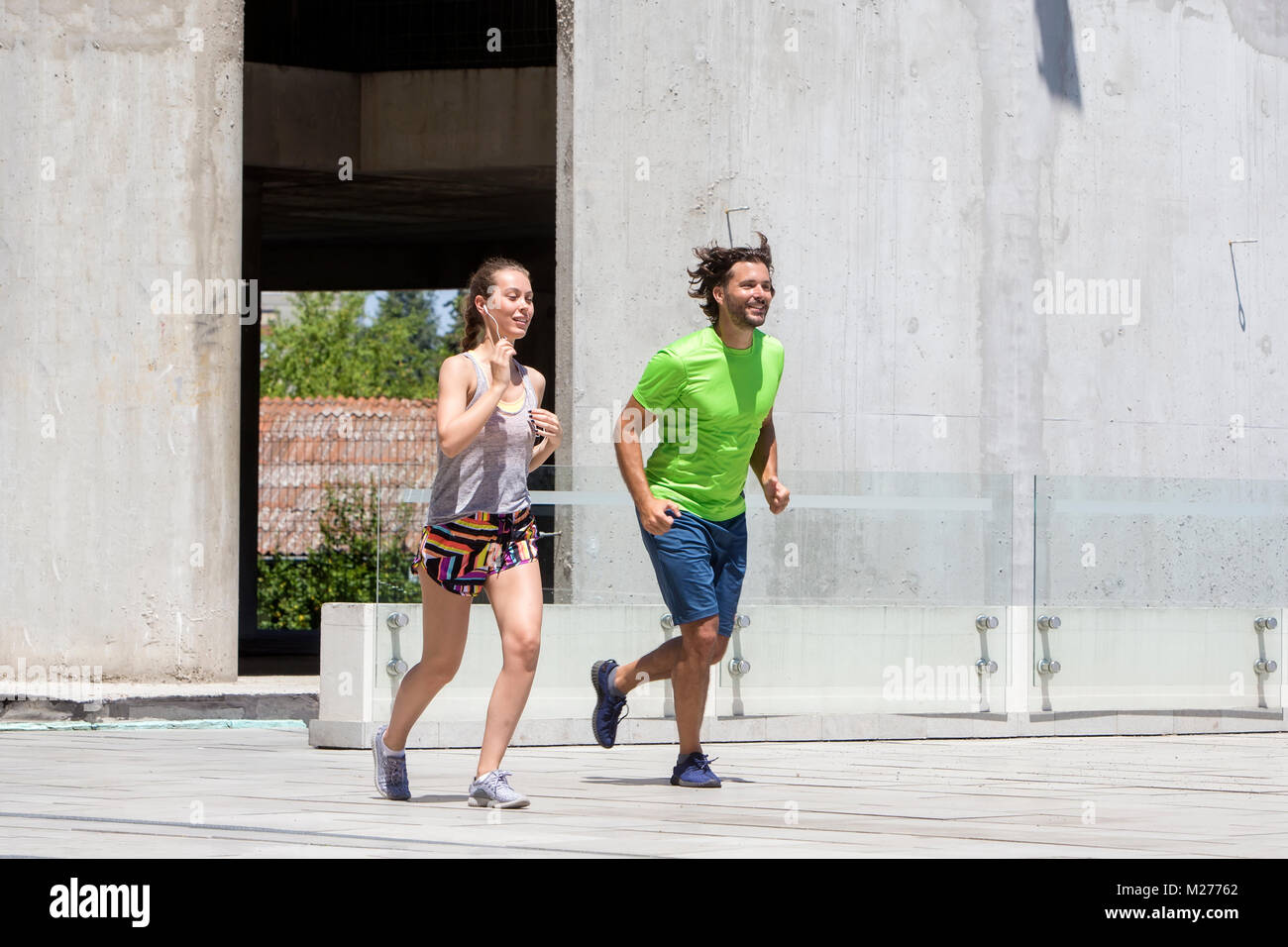 Couple running in urban enviroment at hot summer day Stock Photo - Alamy