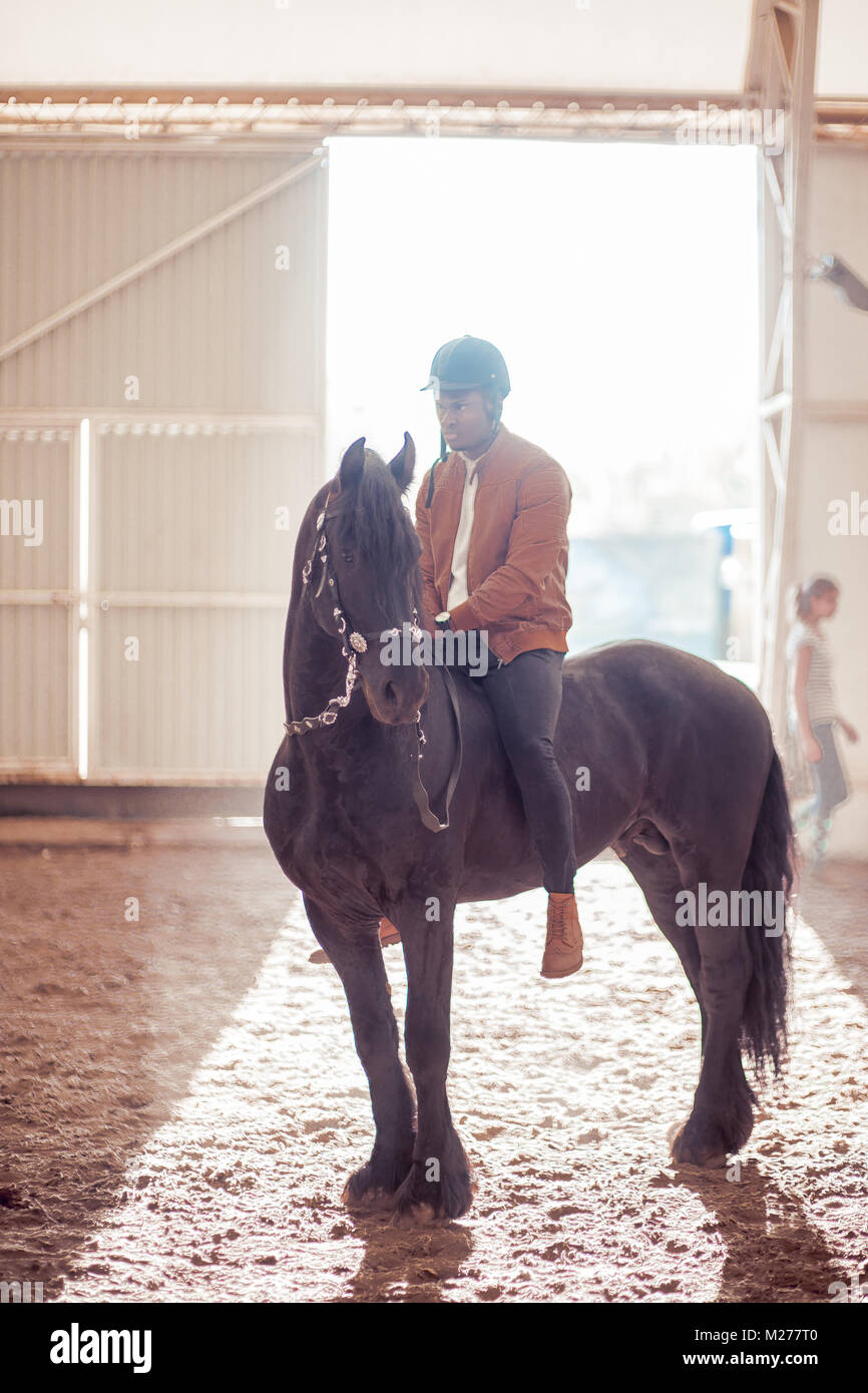 man riding brown horse on countryside Stock Photo - Alamy