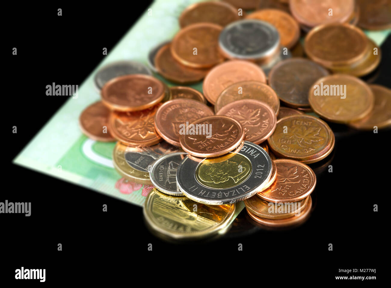 Canadian money on a black background Stock Photo - Alamy
