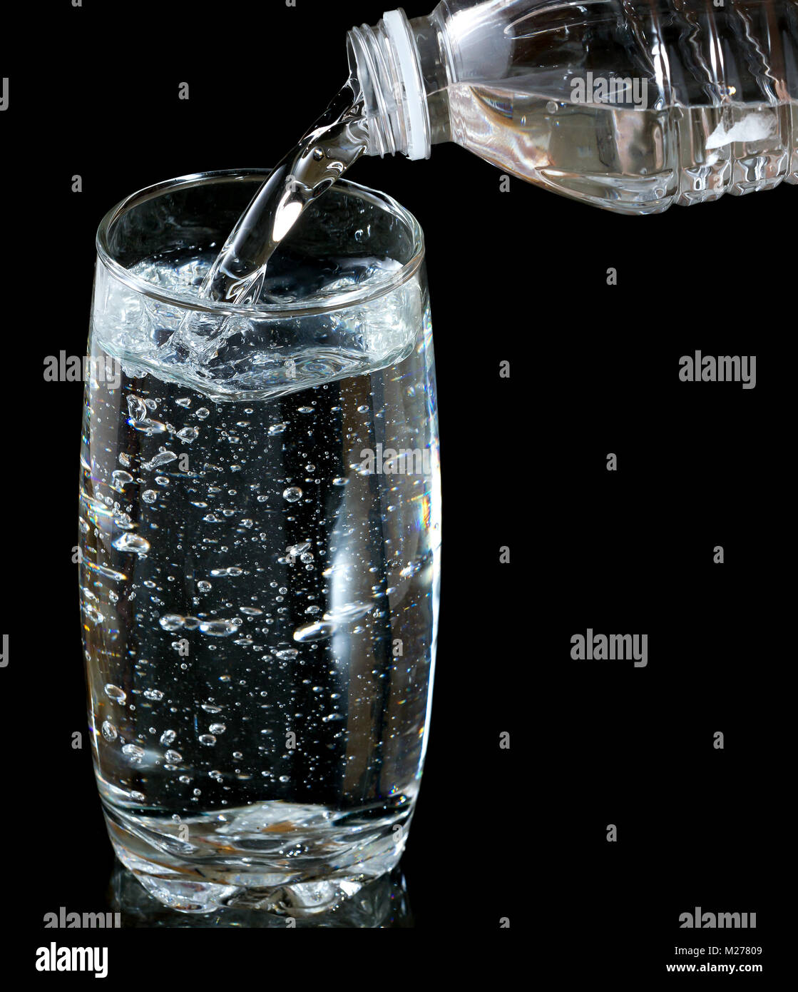 Pouring fresh cold water into the glass from plastic bottle Stock Photo ...