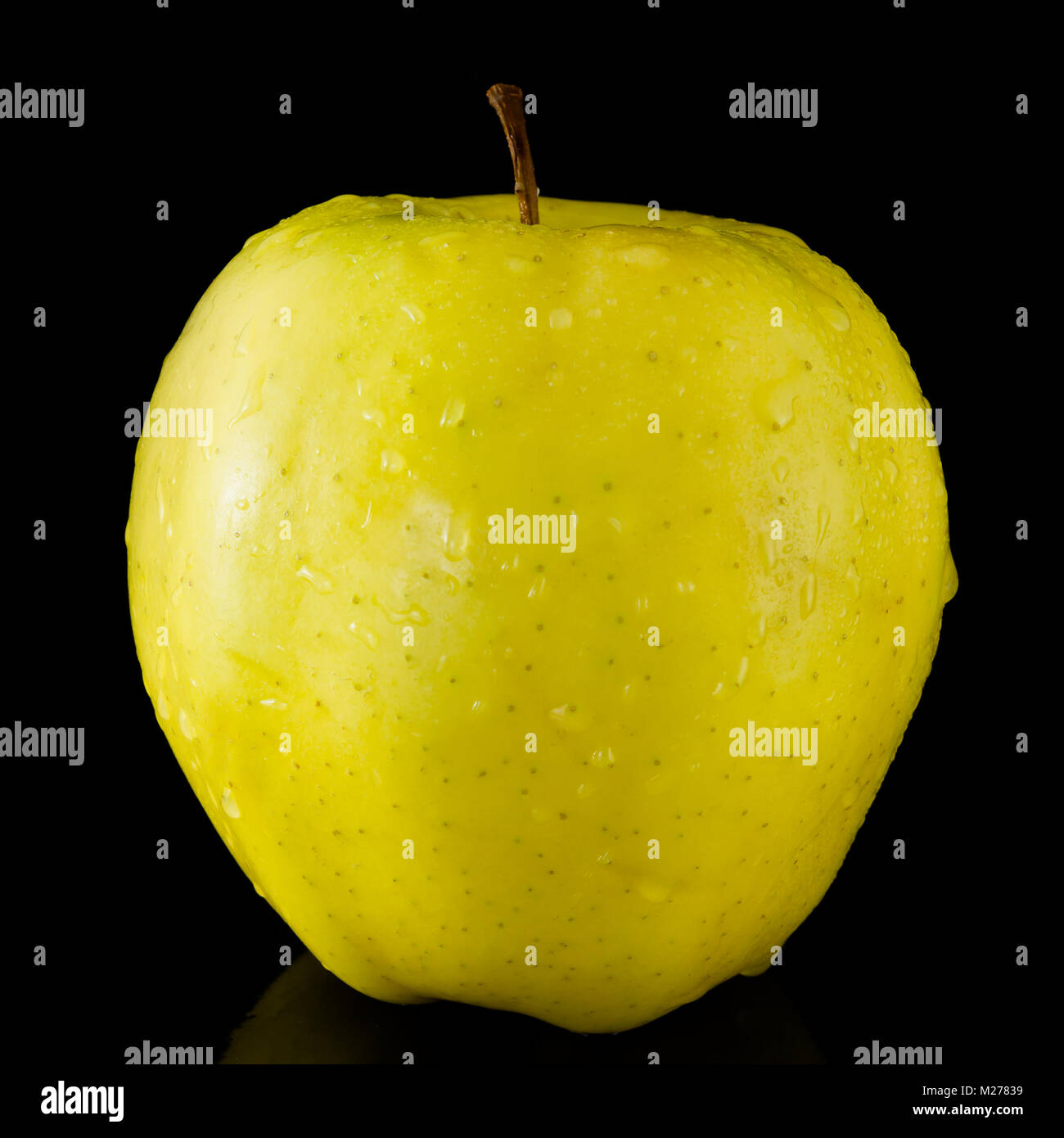 Yellow apple on a black background Stock Photo - Alamy