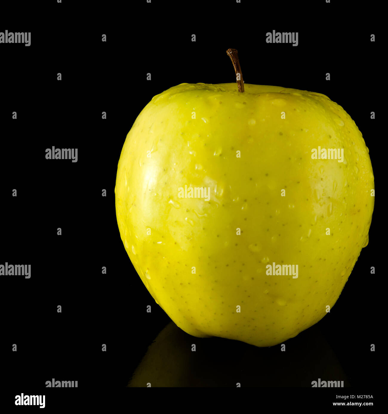 Yellow apple on a black background Stock Photo - Alamy