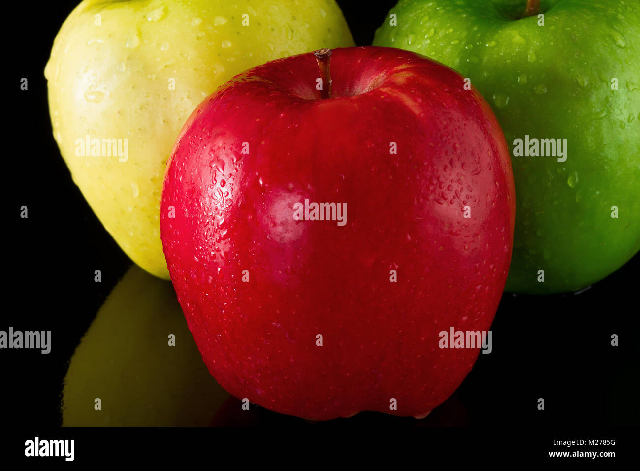 Red, Yellow and Green Apple on a black background Stock Photo - Alamy