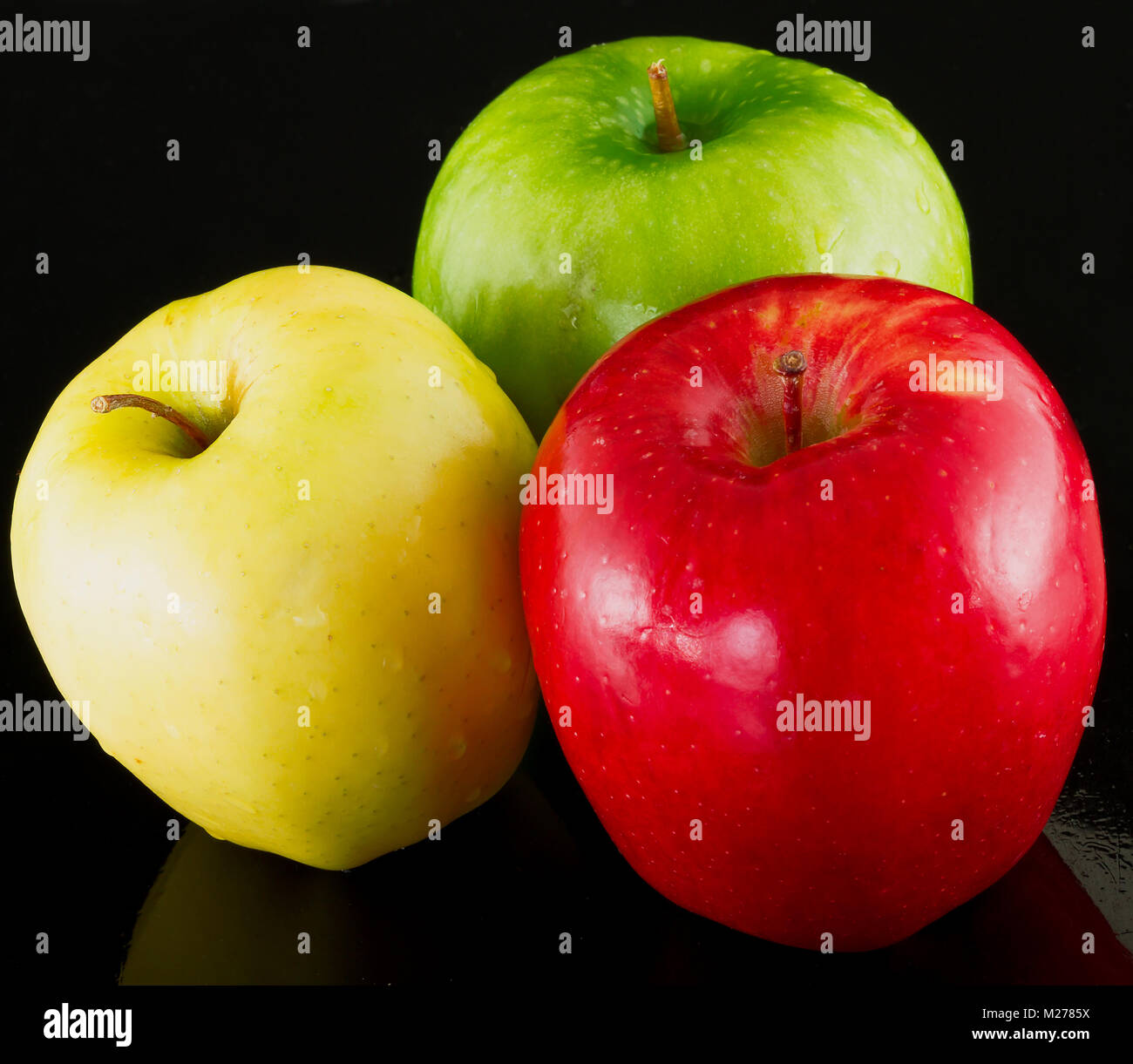 Red, Yellow and Green Apple on a black background Stock Photo - Alamy