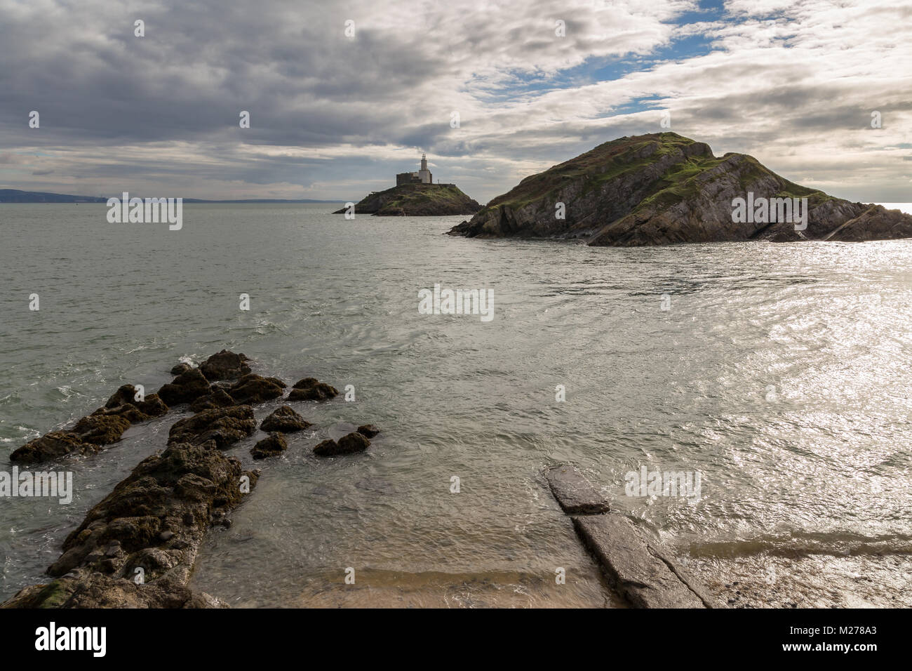 A cloudy day at Mumbles Head Lighthouse in Swansea, Wales, UK Stock ...