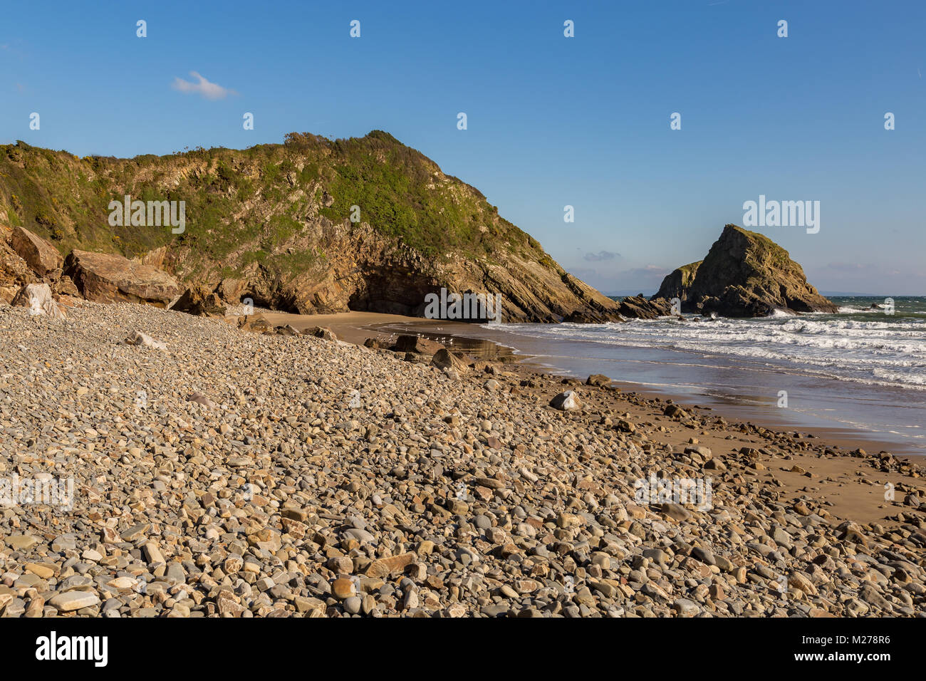 Pebble beach and cliffs at Monkstone Beach near Saundersfoot in ...